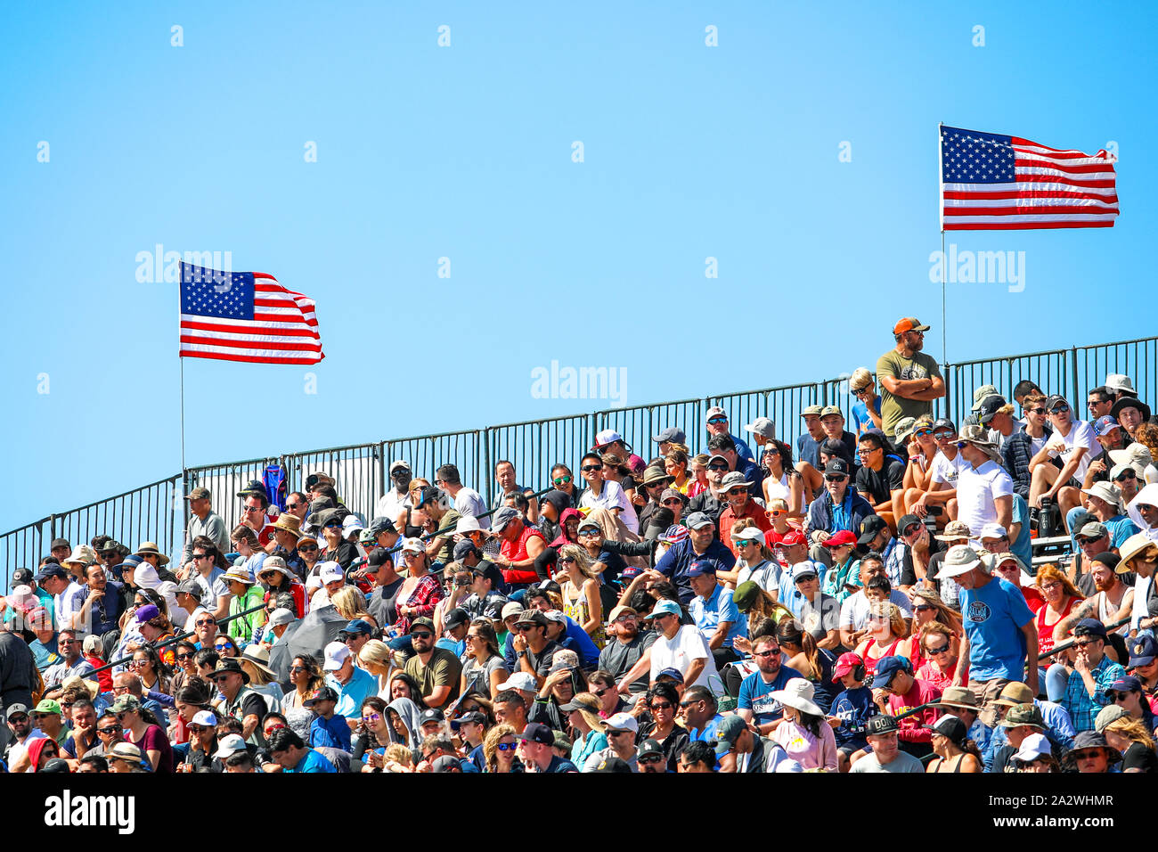 Crowd audience in a stadium, group of people looking and taking photos ...