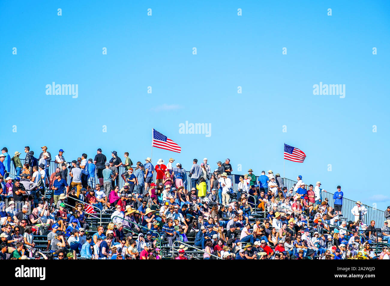 Crowd audience in a stadium, group of people looking and taking photos ...