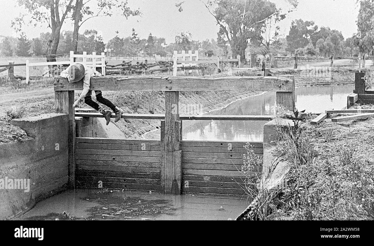 Negative - Young Boy Fishing From the Gates on an Irrigation Channel ...
