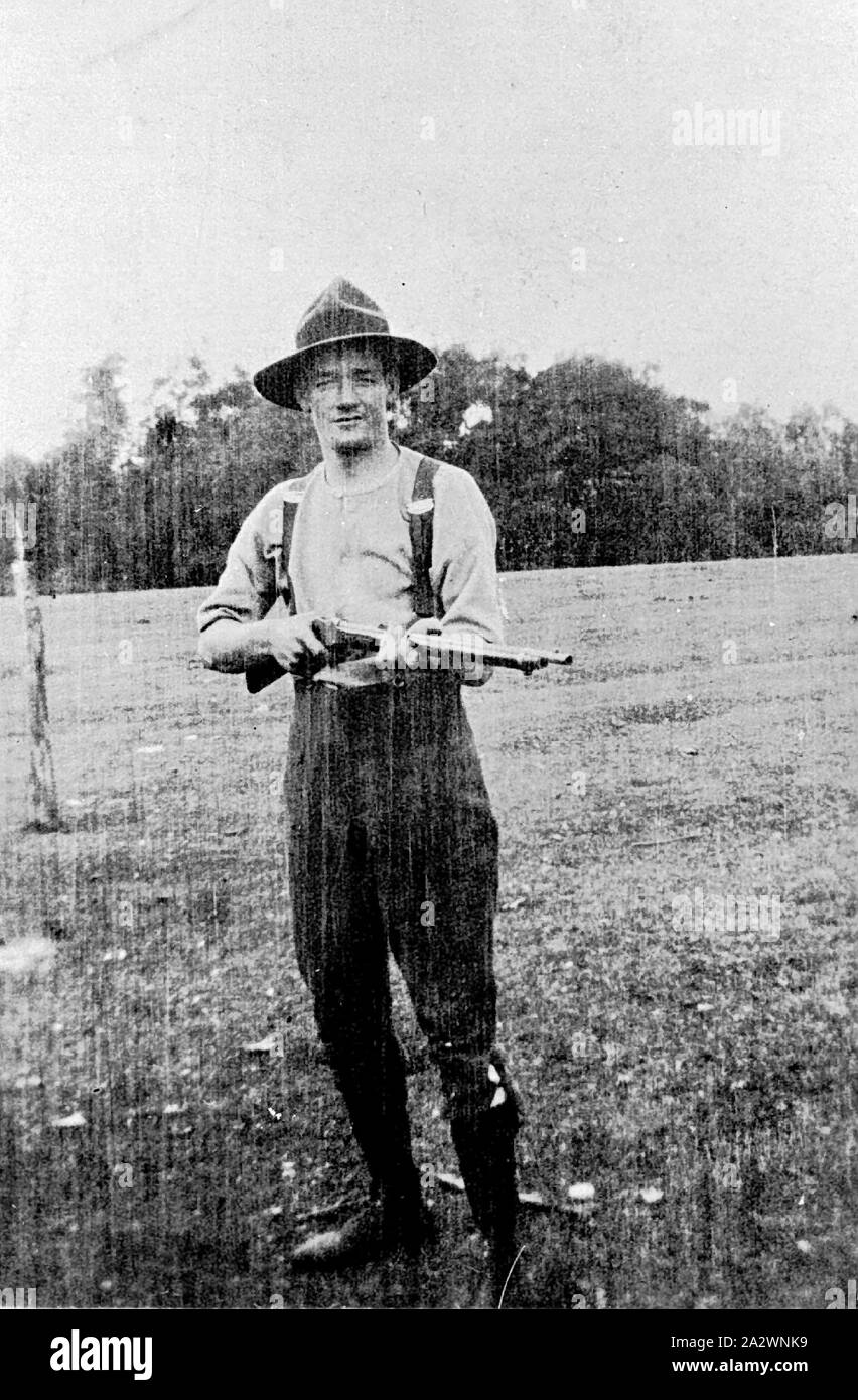 Negative - Victoria (?), circa 1925, A man holding a rifle Stock Photo ...