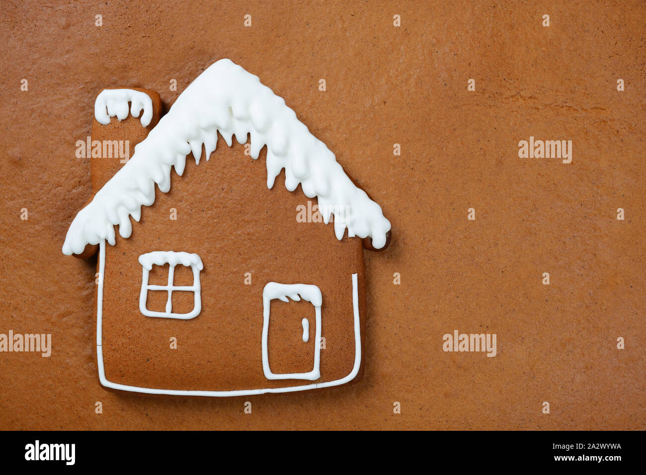 The hand-made eatable gingerbread house on gingerbread background Stock ...