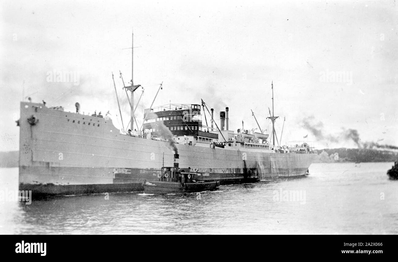 Negative - Australia, circa 1930, A tug with a freighter Stock Photo ...