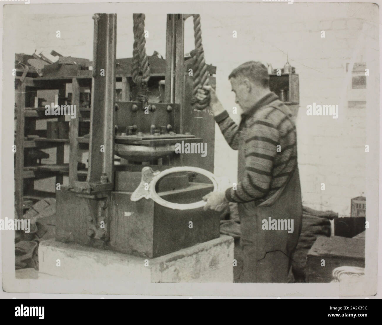 Factory worker operating casting equipment hi-res stock photography and ...