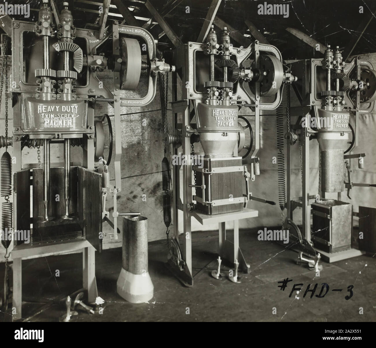 White image depicting three heavy duty twin screw packing machin hi-res ...
