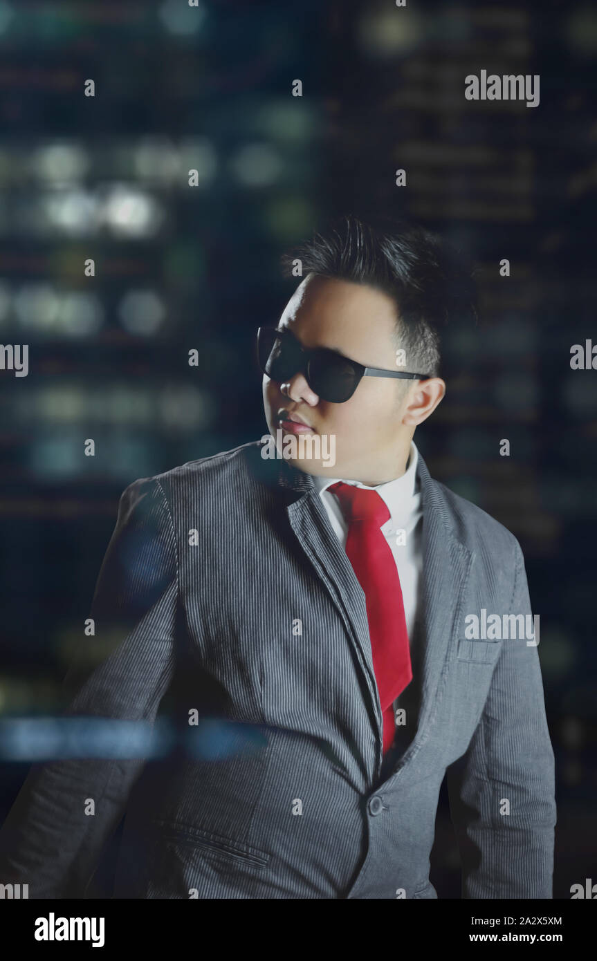 A young man taking a pause while walking and looking back at the left ...