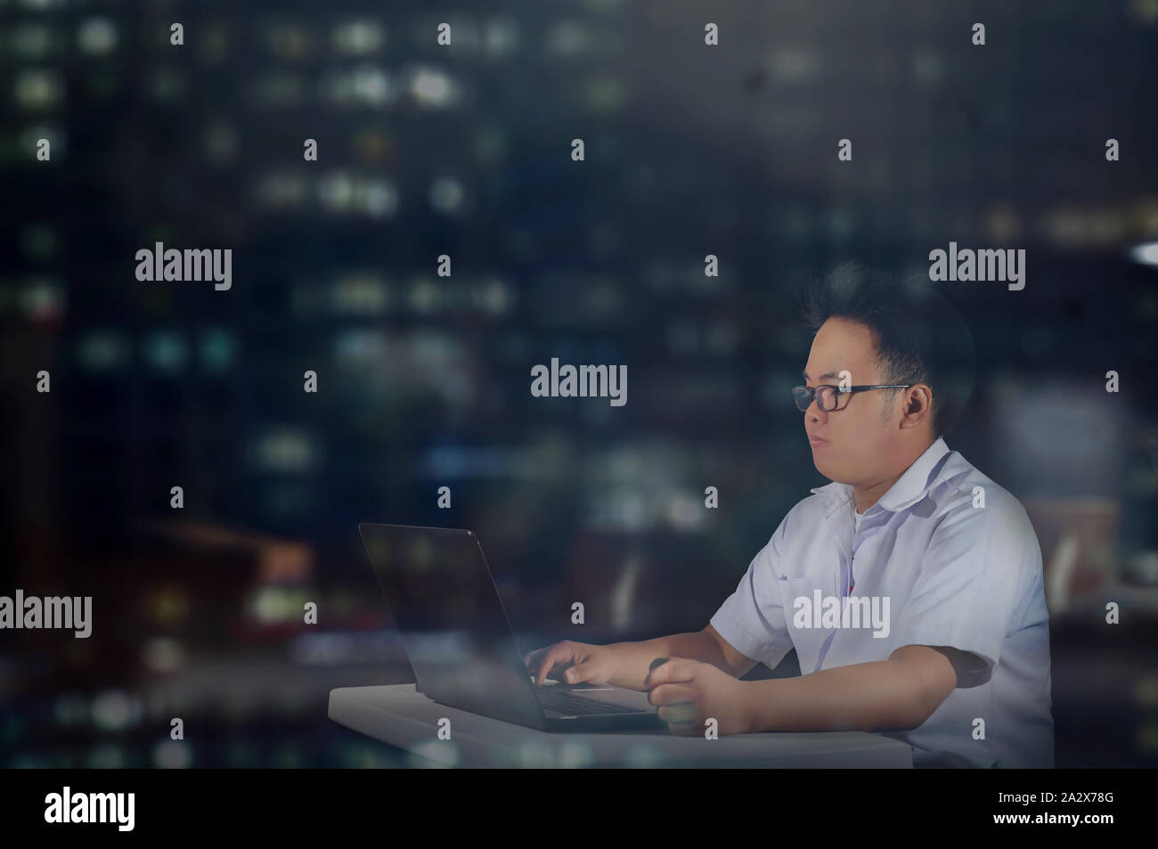 Smart student doing his research. Diligent man working overnight. An ...