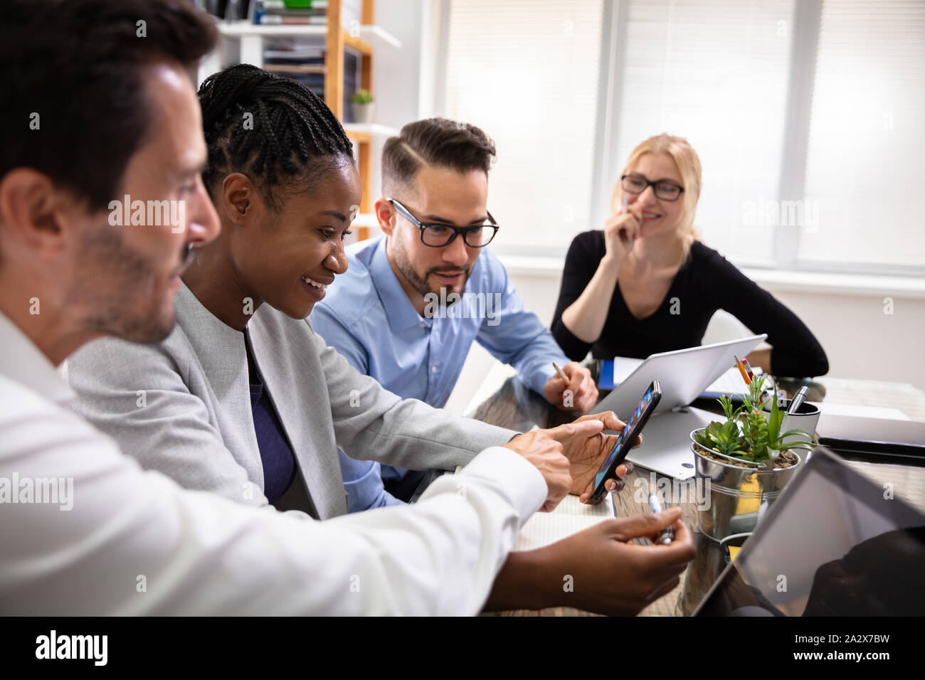 Business man using phone during meeting hi-res stock photography and ...