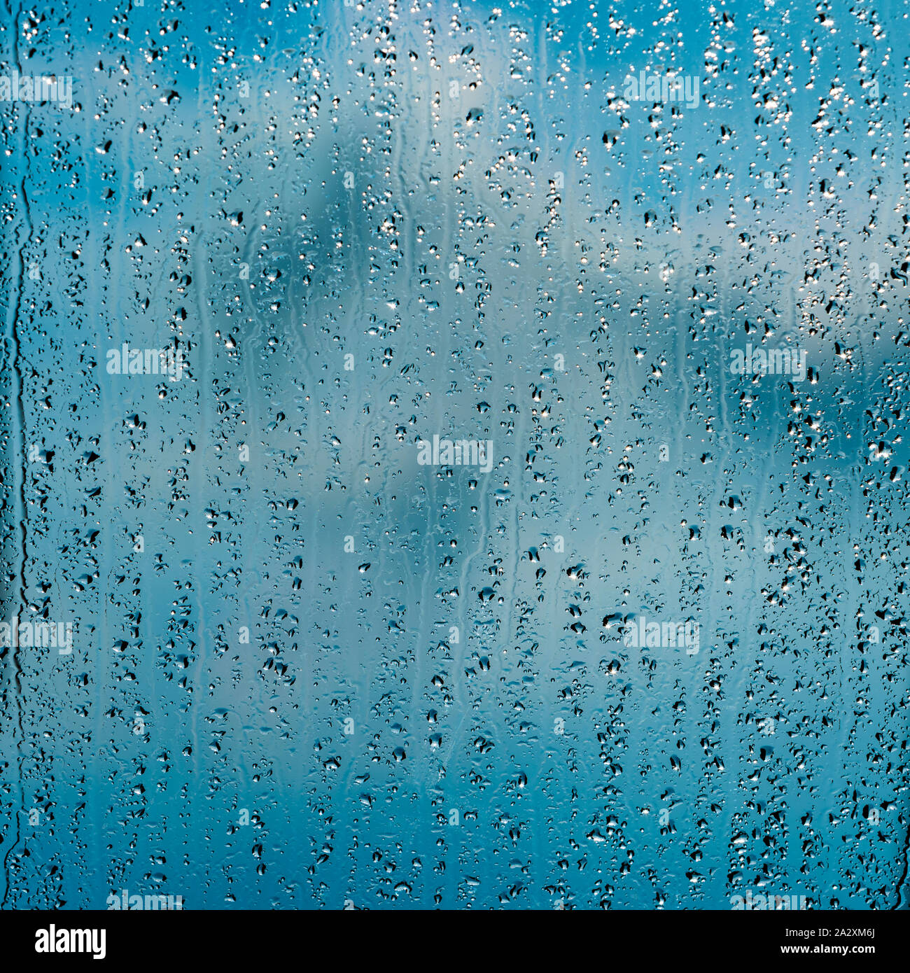 heavy rain drops on blue window Stock Photo - Alamy