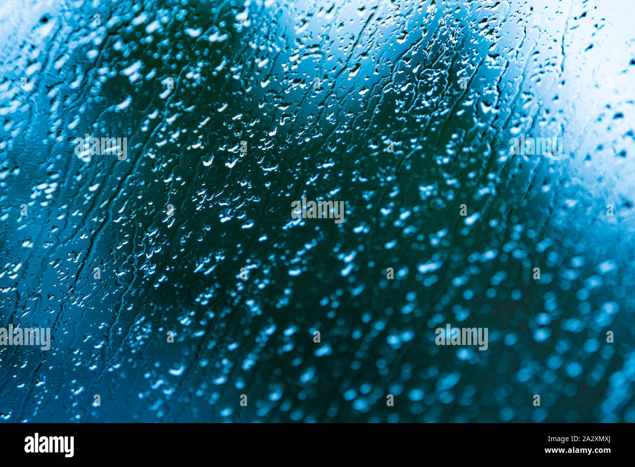 rain drops on window blue background Stock Photo - Alamy