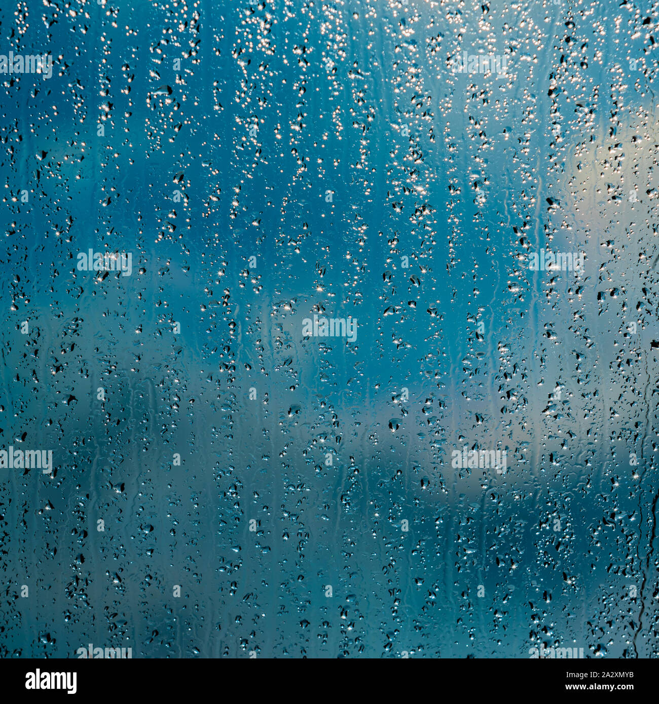 rain drops on window blue background Stock Photo - Alamy