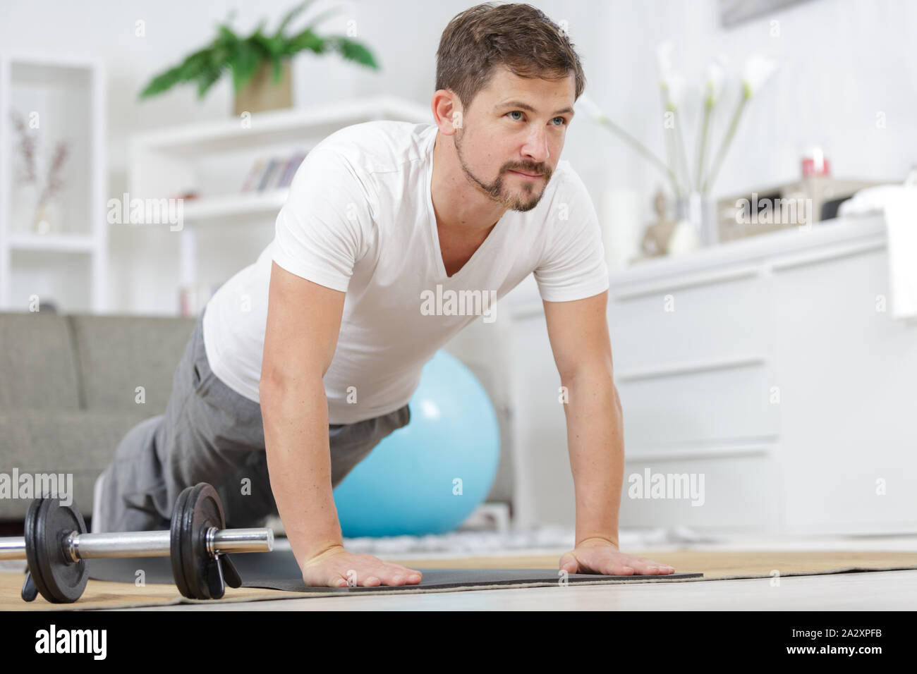 healthy man doing side plank exercise on a mat Stock Photo - Alamy