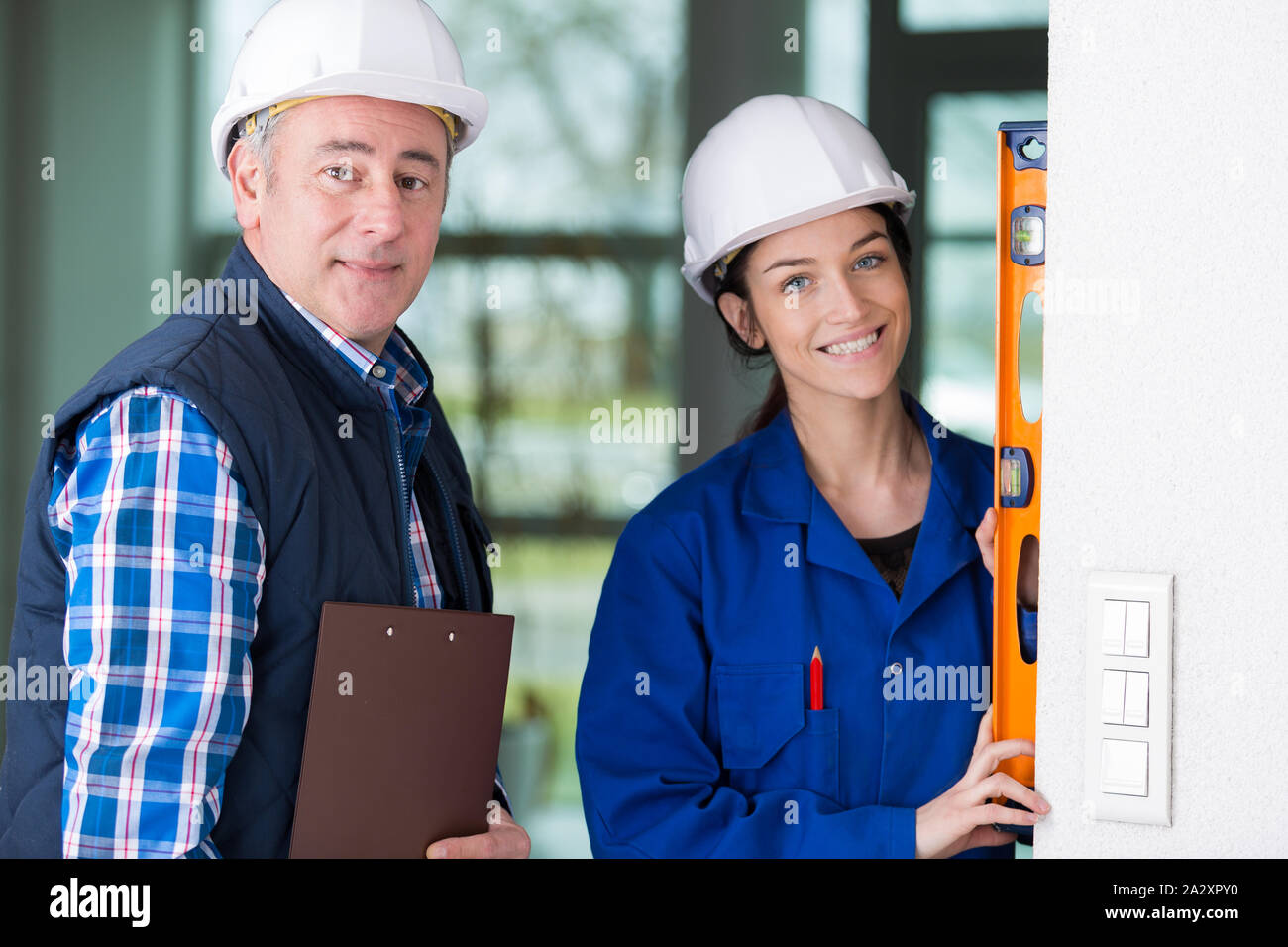 construction worker smile and posing with spirit level Stock Photo - Alamy