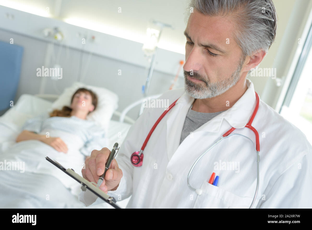 doctor writing on clipboard paper Stock Photo - Alamy