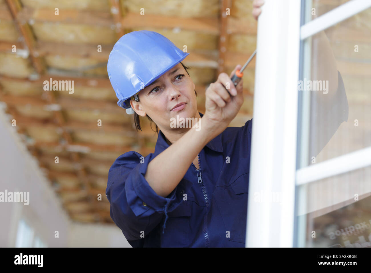 a woman is fixing a window Stock Photo - Alamy