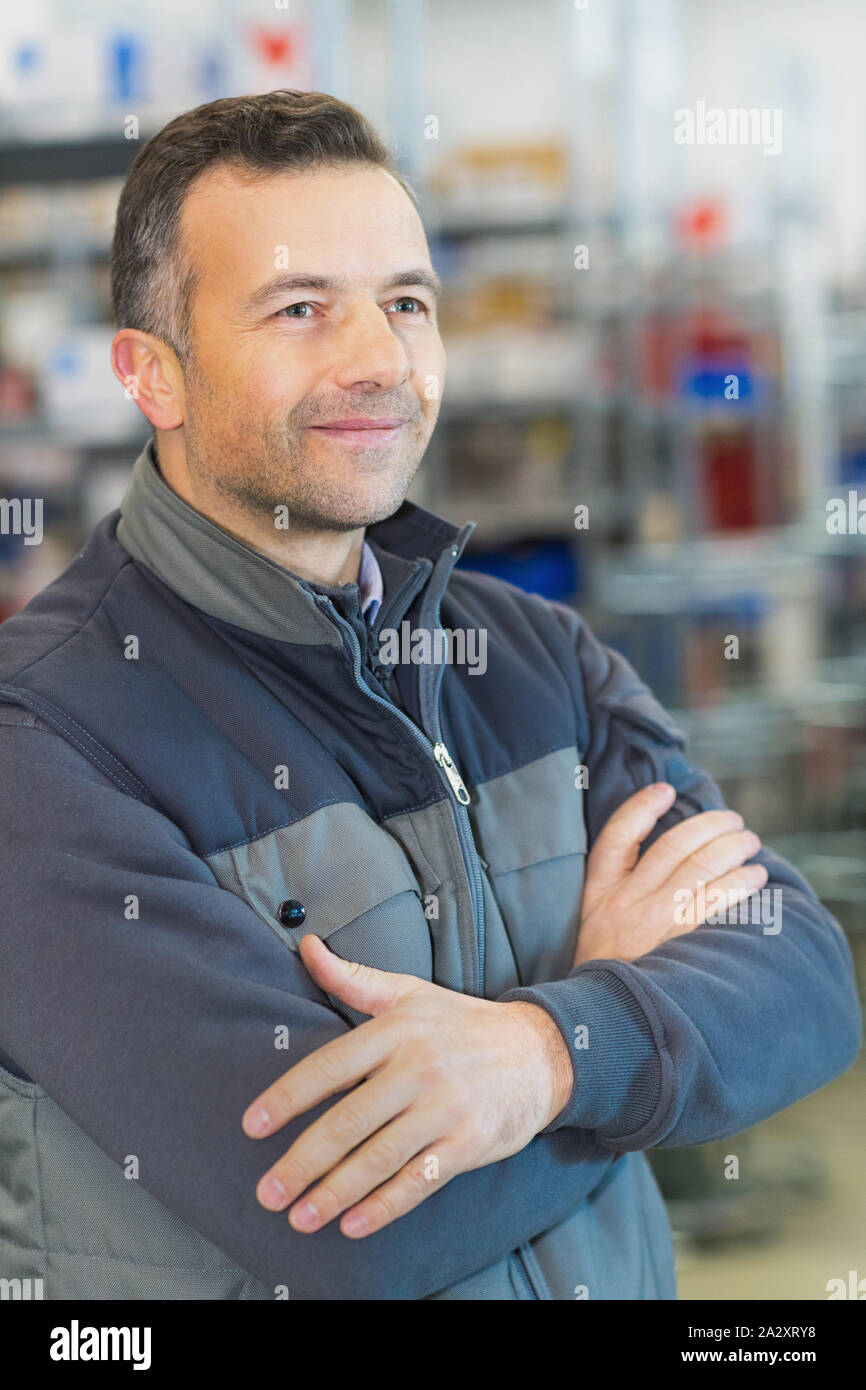 male laborer posing and smiling confidently Stock Photo - Alamy