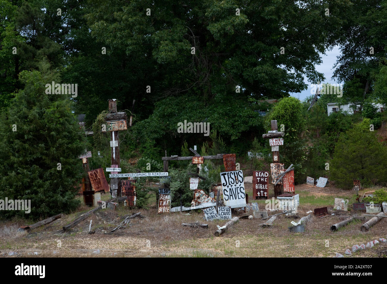 Rough wooden crosses and peeling hand-lettered signs bearing Bible ...