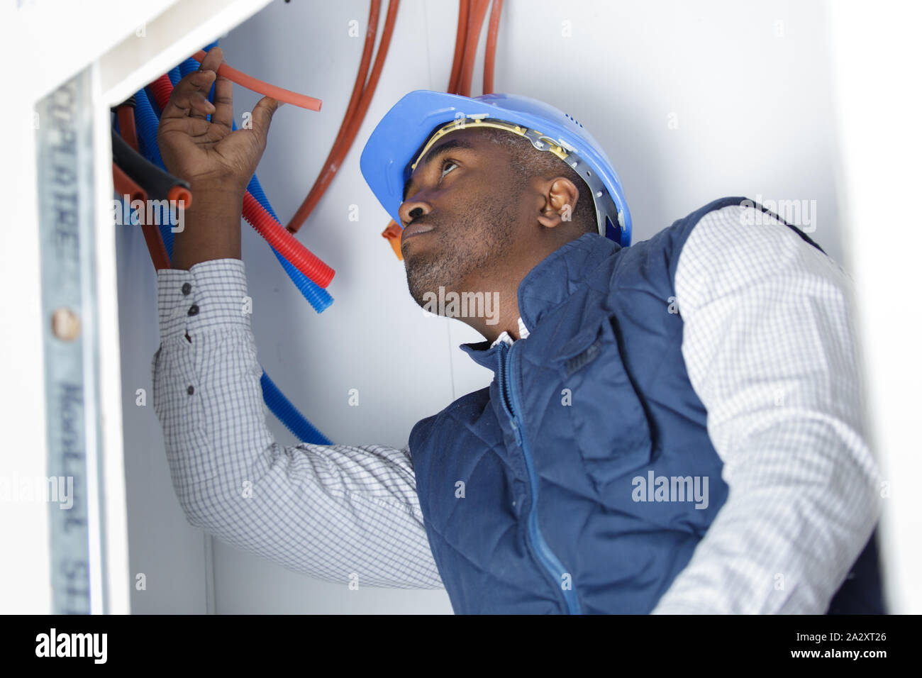 the electrician is fixing an electric corrugated tube Stock Photo - Alamy