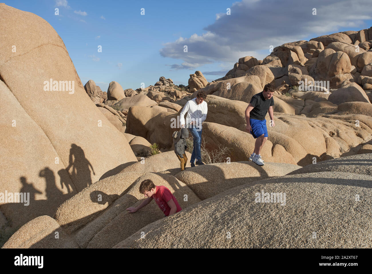 Hikers navigate their ways along jumbo rocks in Joshua Tree National ...