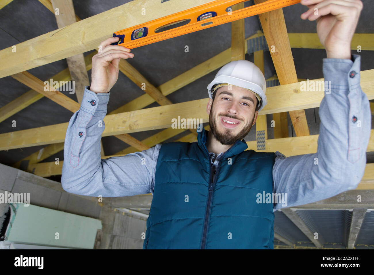 construction worker using spirit level to check a beam Stock Photo - Alamy