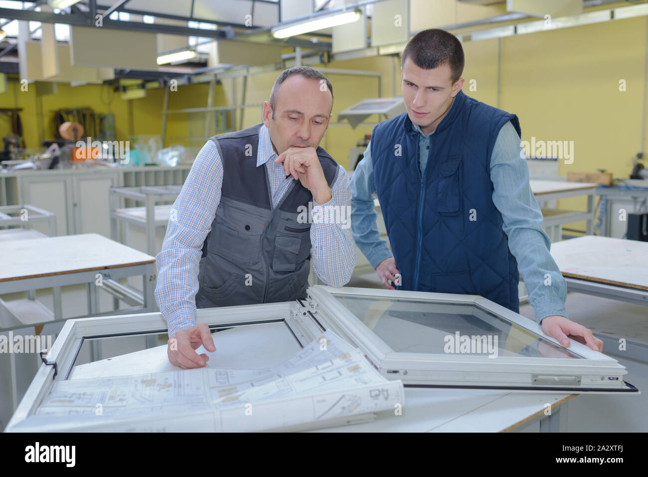 production workers with different pvc window Stock Photo - Alamy