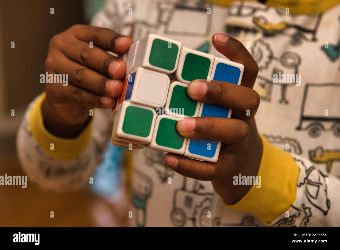 Child solving rubiks cube hi-res stock photography and images - Alamy