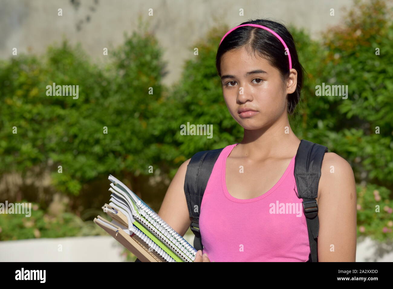 Depressed Filipina Female Student With Textbooks Stock Photo - Alamy
