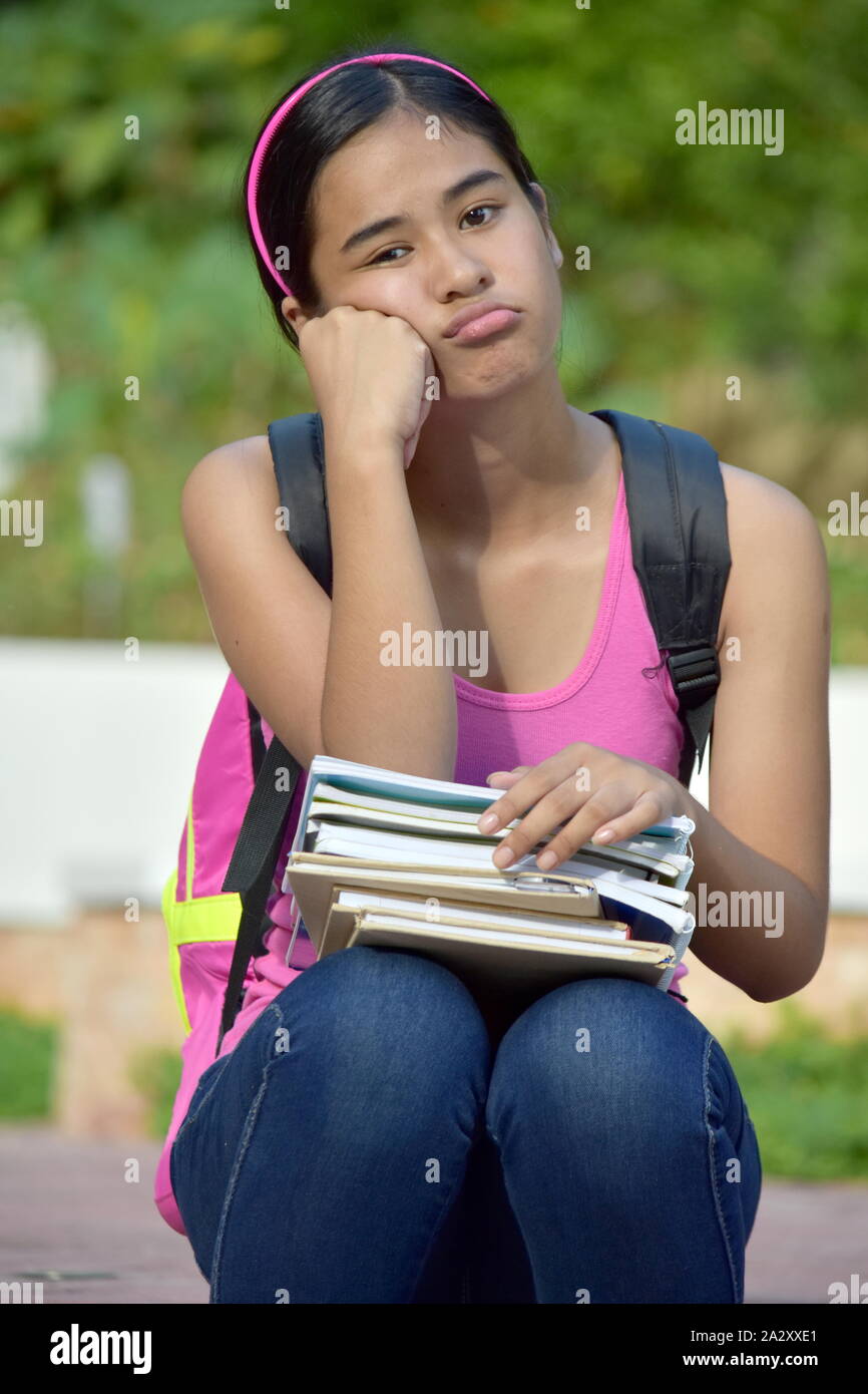 Bored Filipina Female Student With Textbooks Stock Photo - Alamy