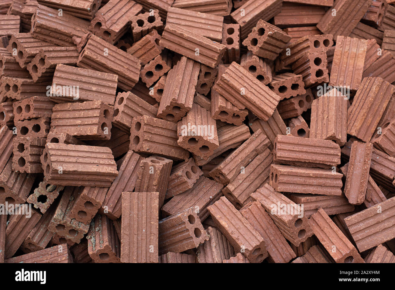 Red brick piles texture background Stock Photo - Alamy