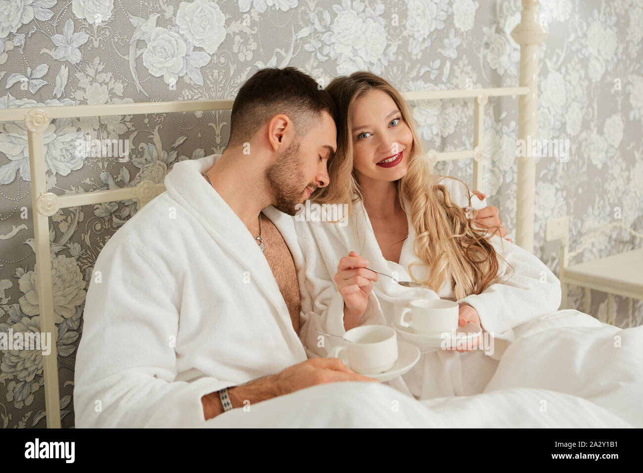 Young romantic couple drinking coffee in bed Stock Photo - Alamy