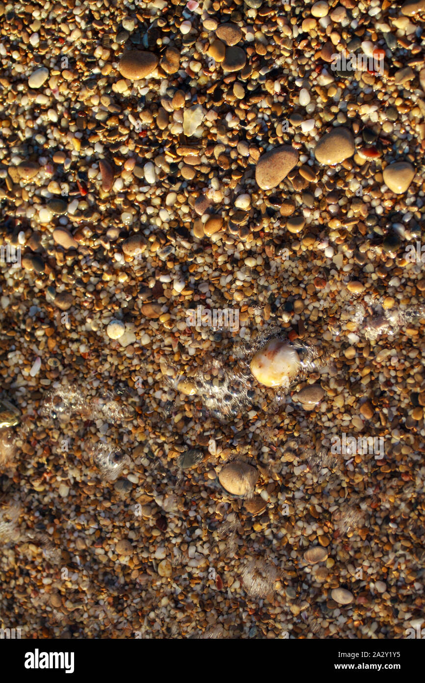 sea pebbles colored granite on the beach background stones. The shore ...