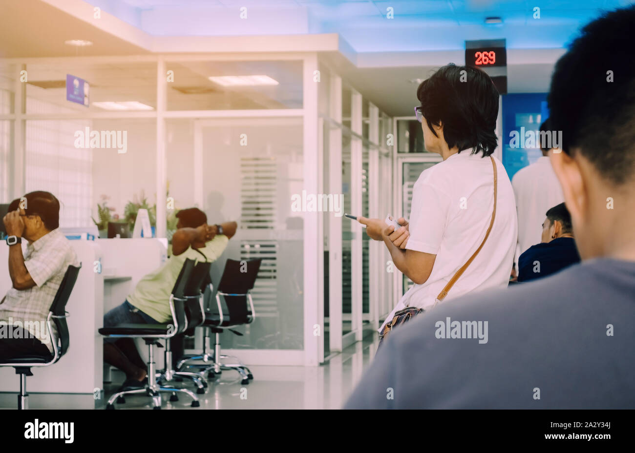 Back view of people sit and waiting in financial transactions in the ...
