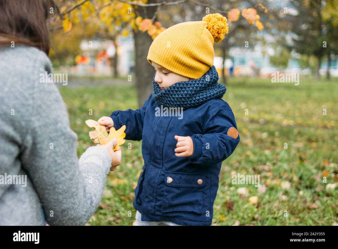 Cute baby boy in fashionable casual clothes explores the world with ...