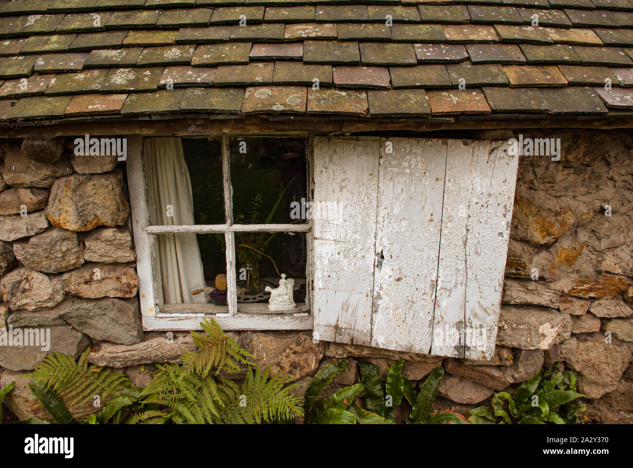 Window in stone cottage with open shutter below tiled roof Stock Photo ...