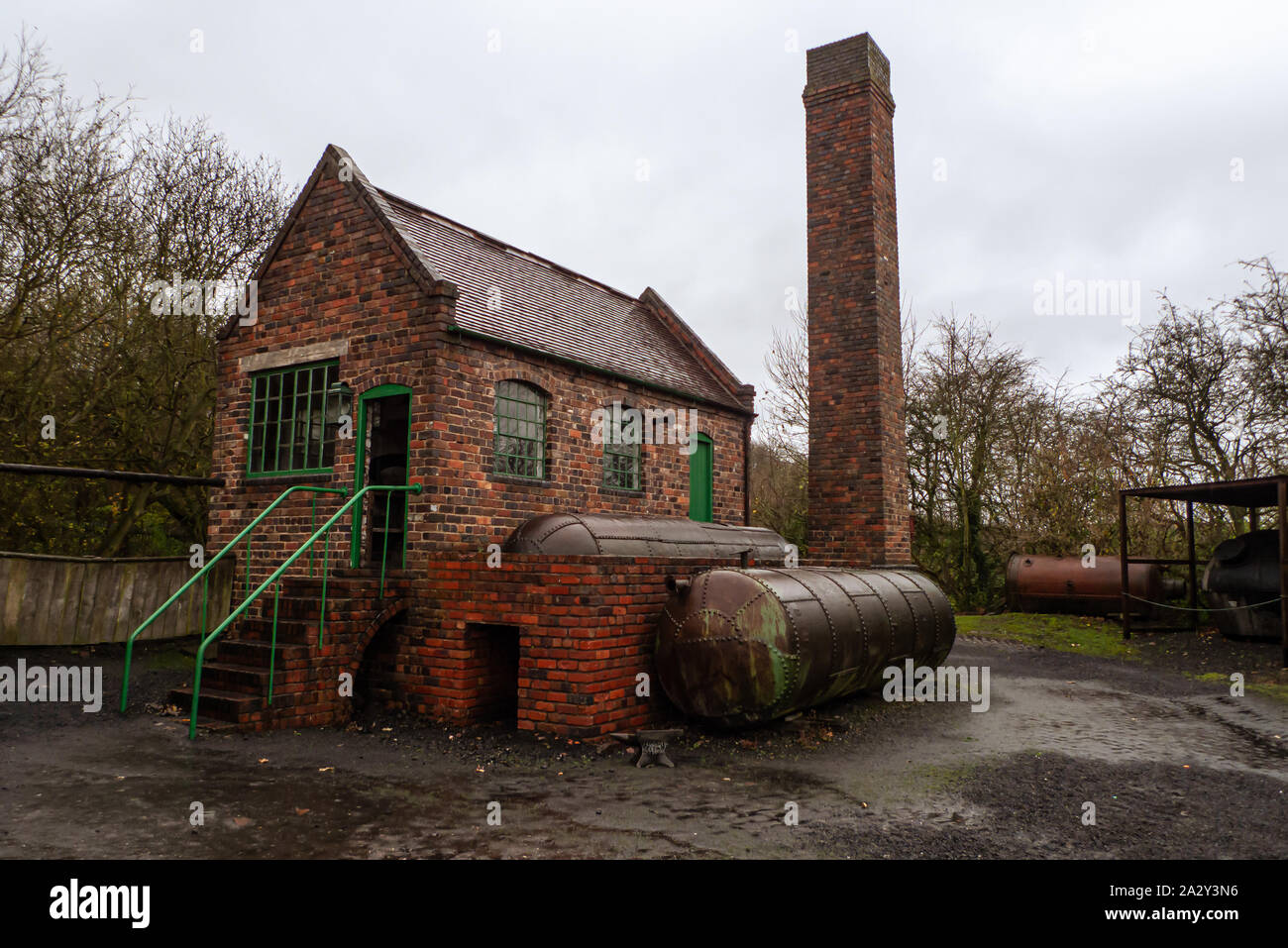 Old steam winding house with pressure cylinder beside chimney Stock ...