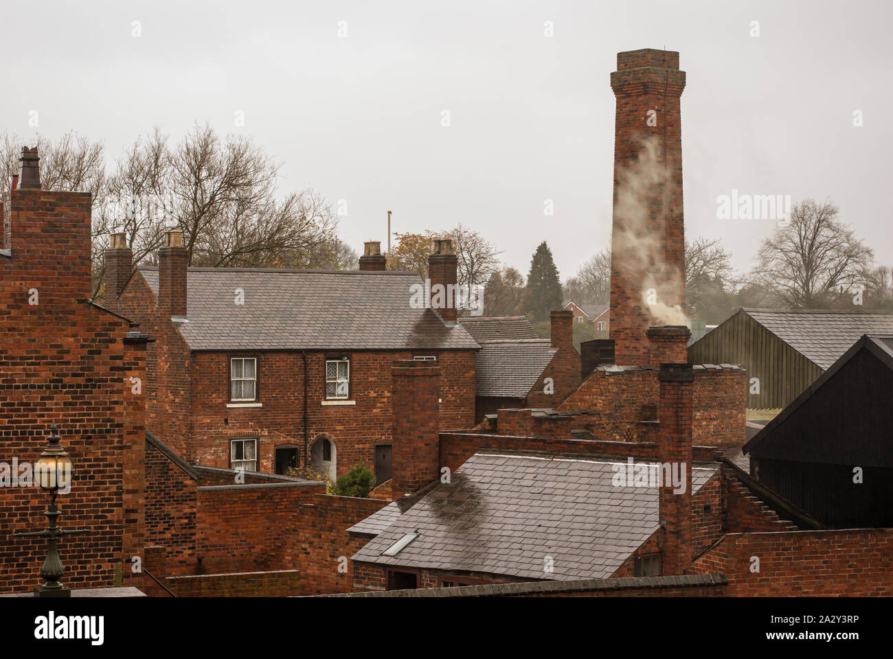 Industrial rooftop scene with chimneys and smoke Stock Photo - Alamy