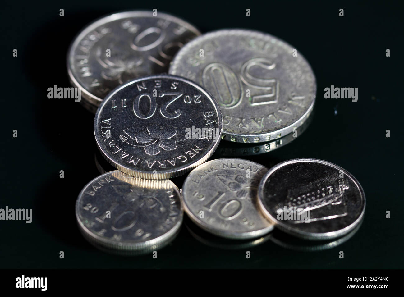 Malaysian currency coins in various denomination on a black mirror ...