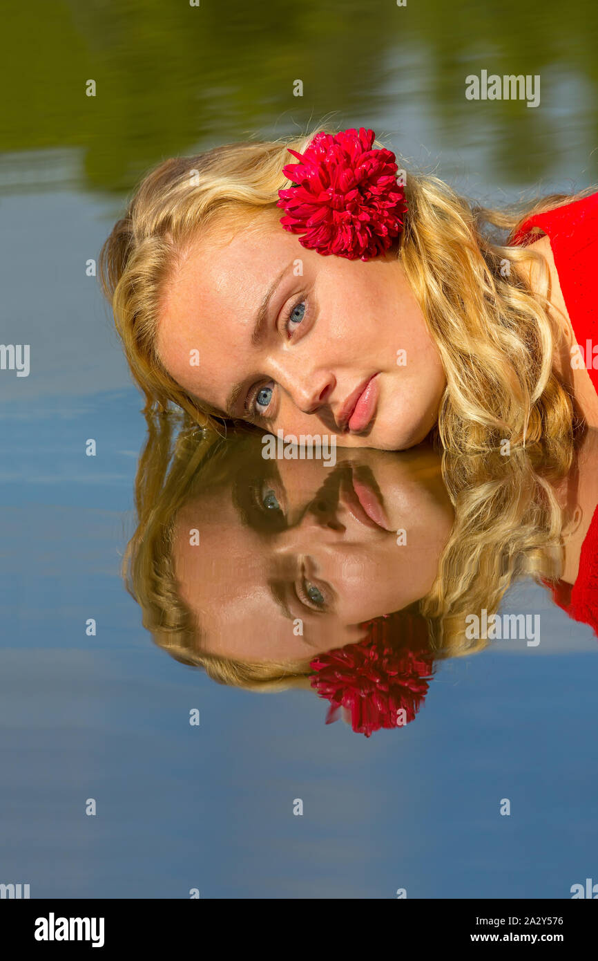 Portrait of young dutch woman with head reflectiing in water Stock ...