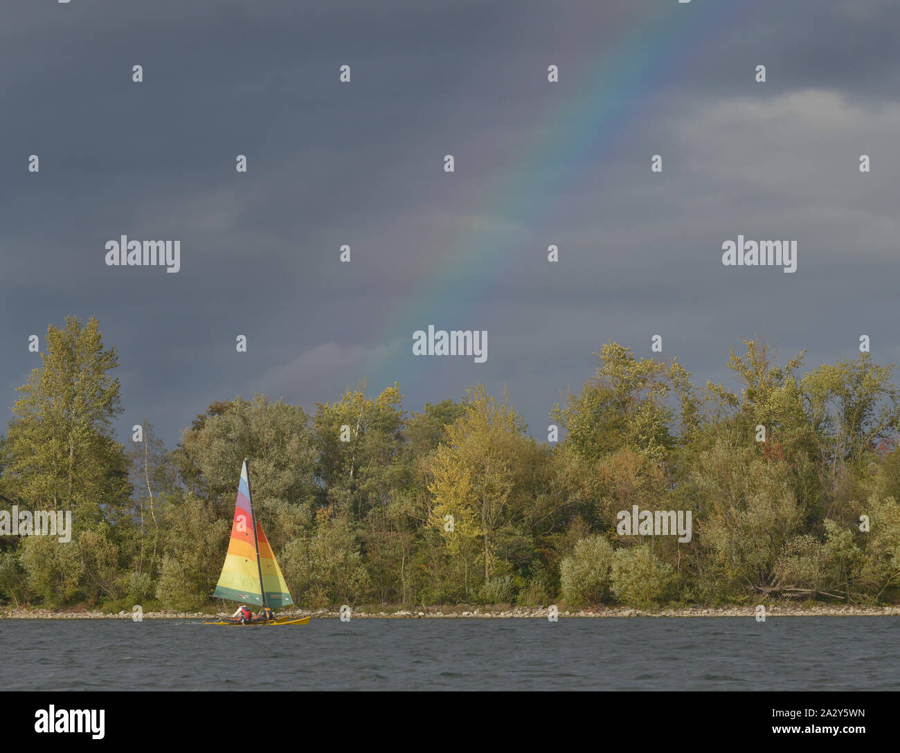 Sailboat with rainbow Stock Photo - Alamy