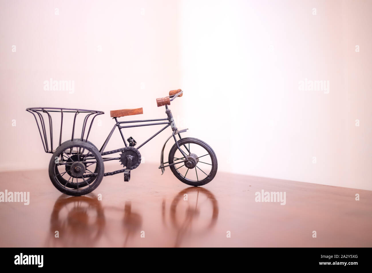 Toy bicycle or Indian style rickshaw isolated on a pink background ...