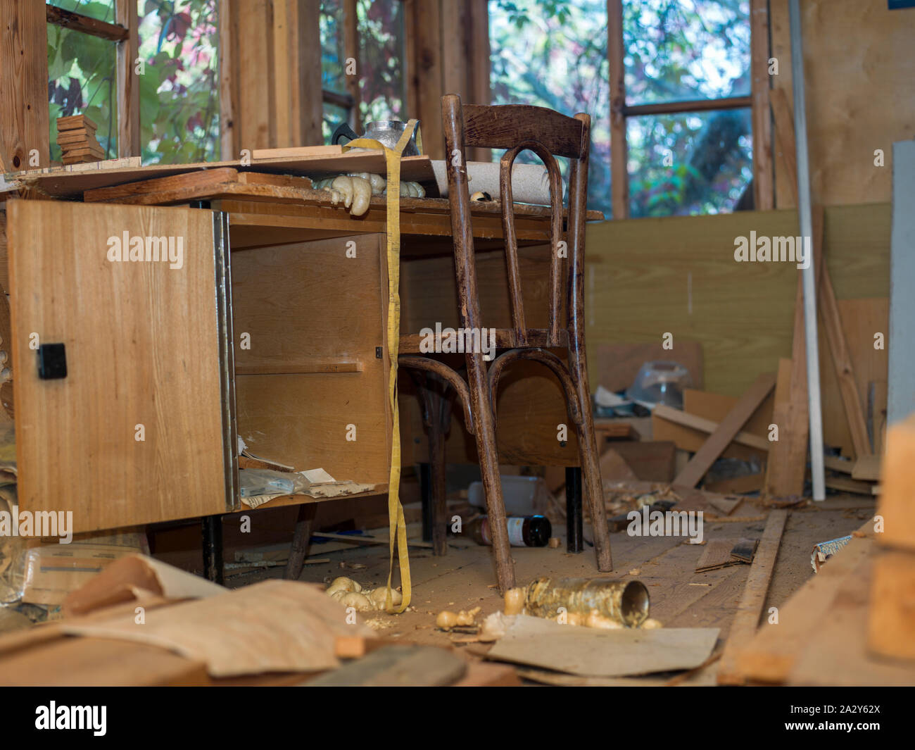 Broken furniture in a messy room, interior of seemingly abandoned house ...