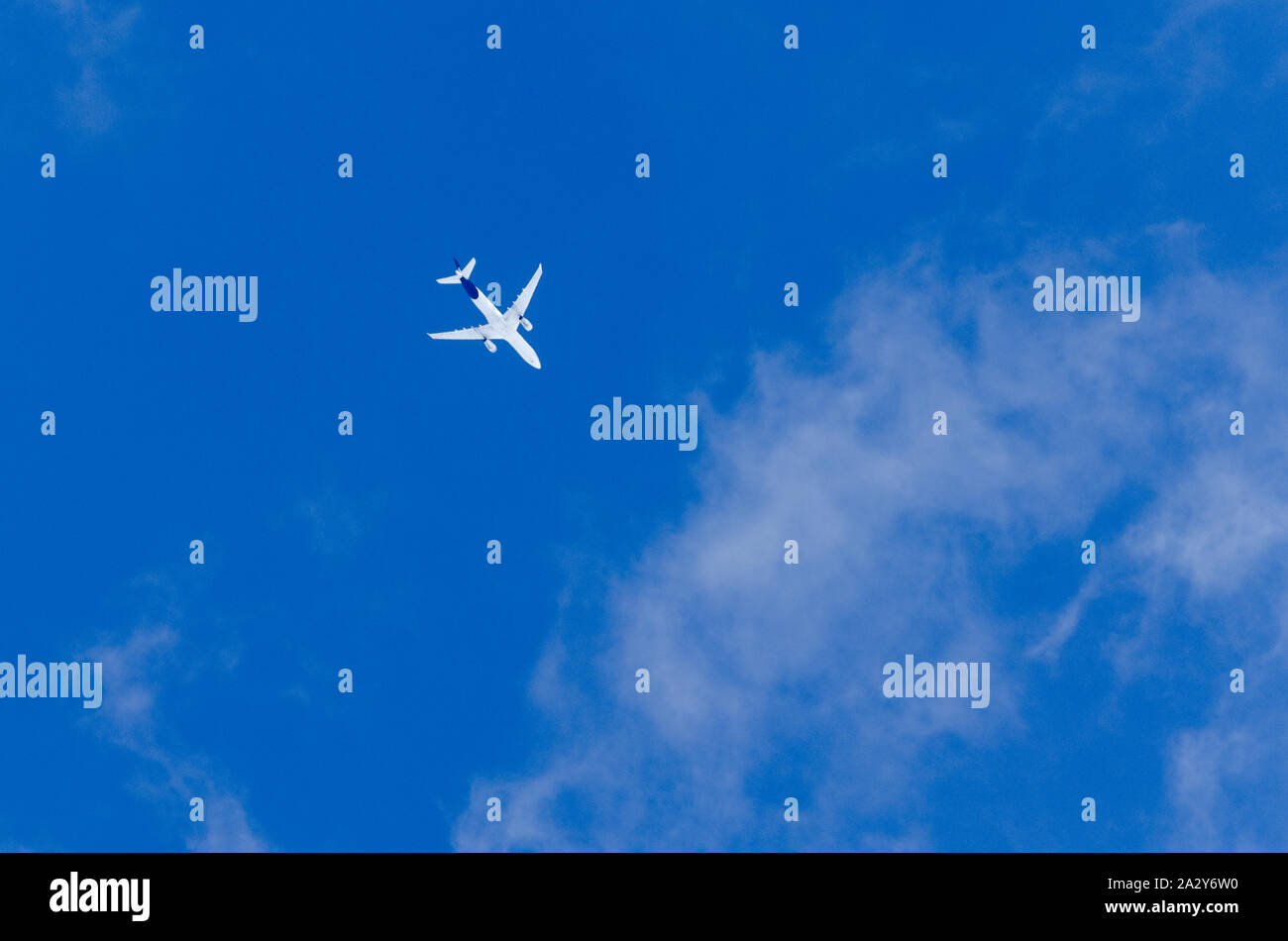 Lufthansa Boeing B737 flying against blue sky and clouds Stock Photo ...