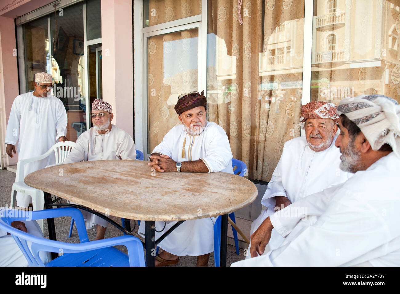Omani men in traditional clothing and wearing a traditional headcloth ...