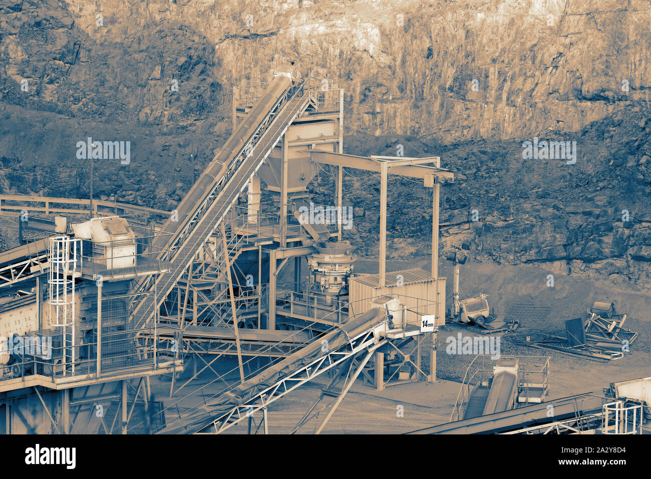 Machinery at a quarry with piles of sand and aggregate in the ...