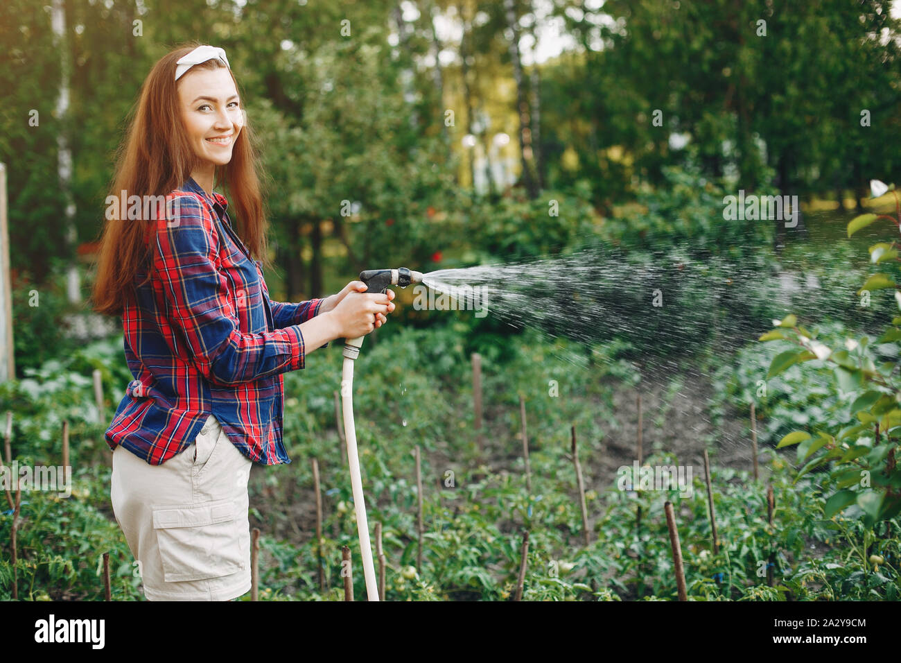 Lady watering hi-res stock photography and images - Alamy