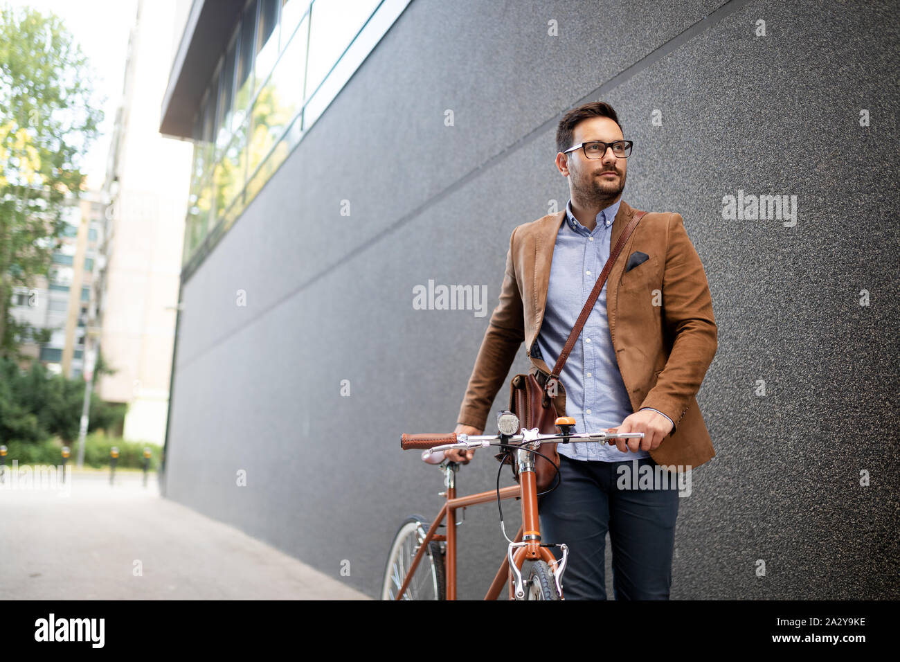 Happy businessman riding bicycle to work in morning Stock Photo - Alamy