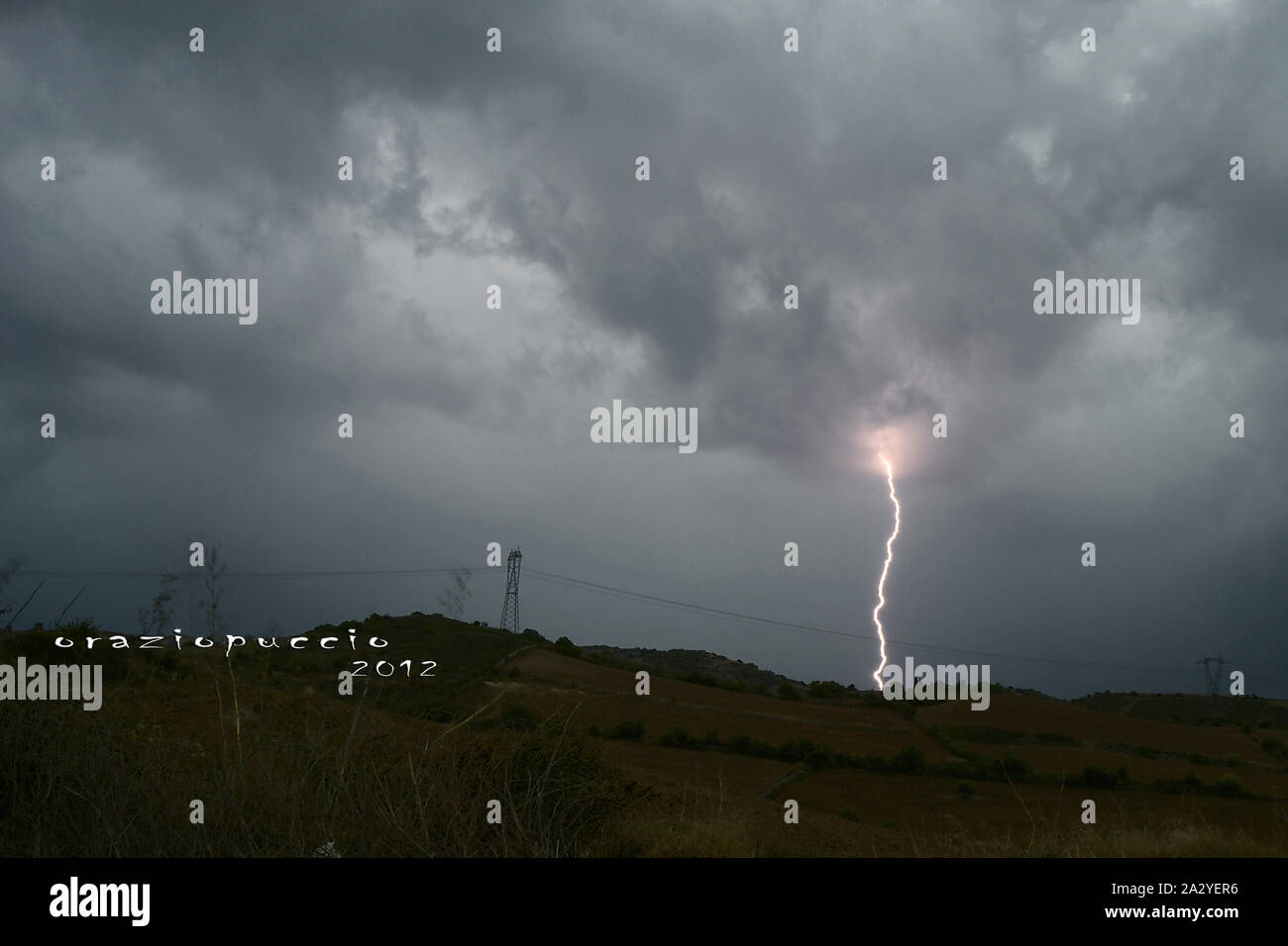 with lightning striking a hill Stock Photo - Alamy