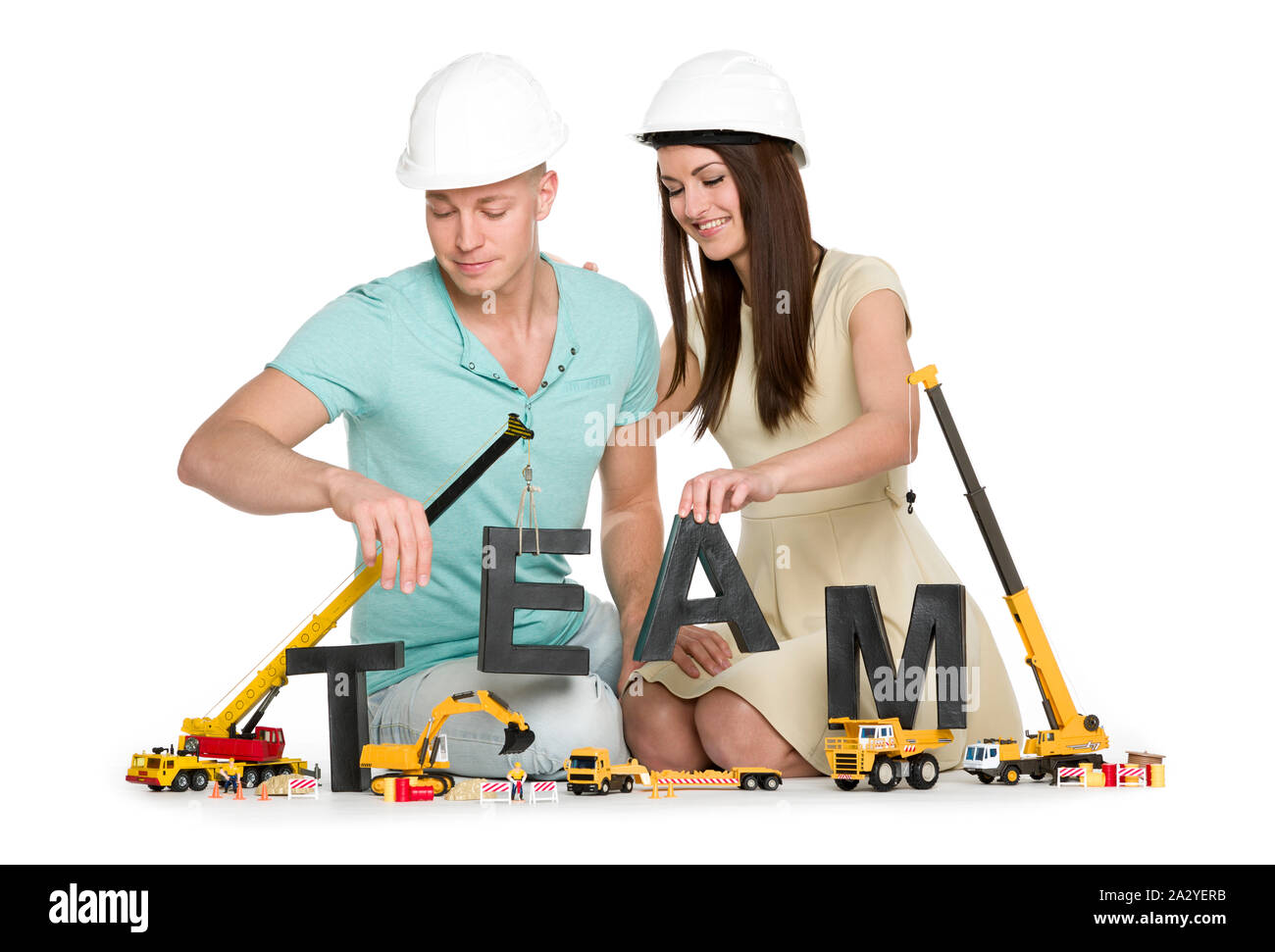 Forming a team: Joyous man and woman building team-word Stock Photo - Alamy