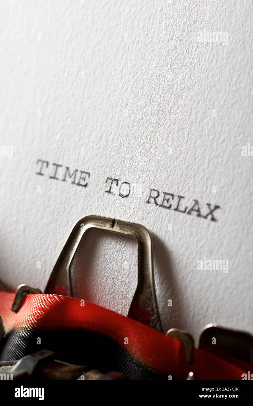The sentence, Time to relax, written with a typewriter Stock Photo - Alamy
