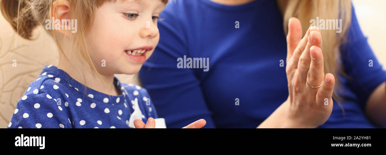 Cute little girl play with mom pat-a-cake Stock Photo - Alamy