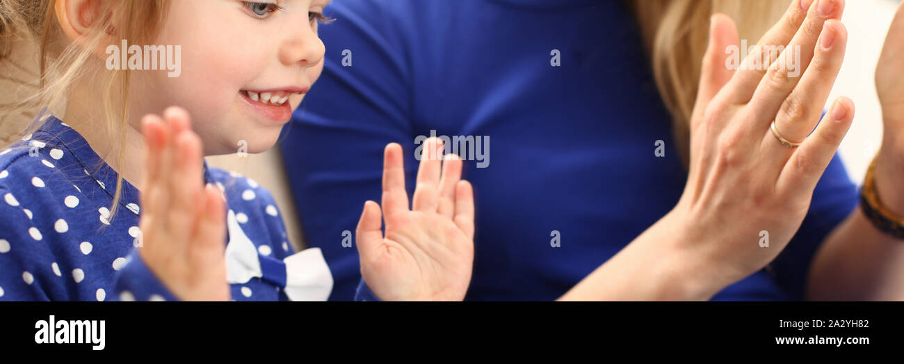 Cute little girl play with mom pat-a-cake Stock Photo - Alamy